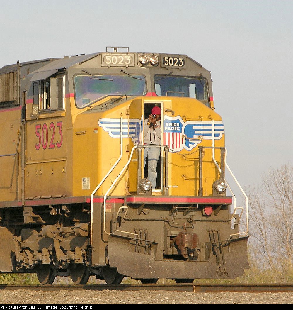 His hobby must be taking pictures of Rail Fans, or maybe, smile, you are on Special Agent camera?